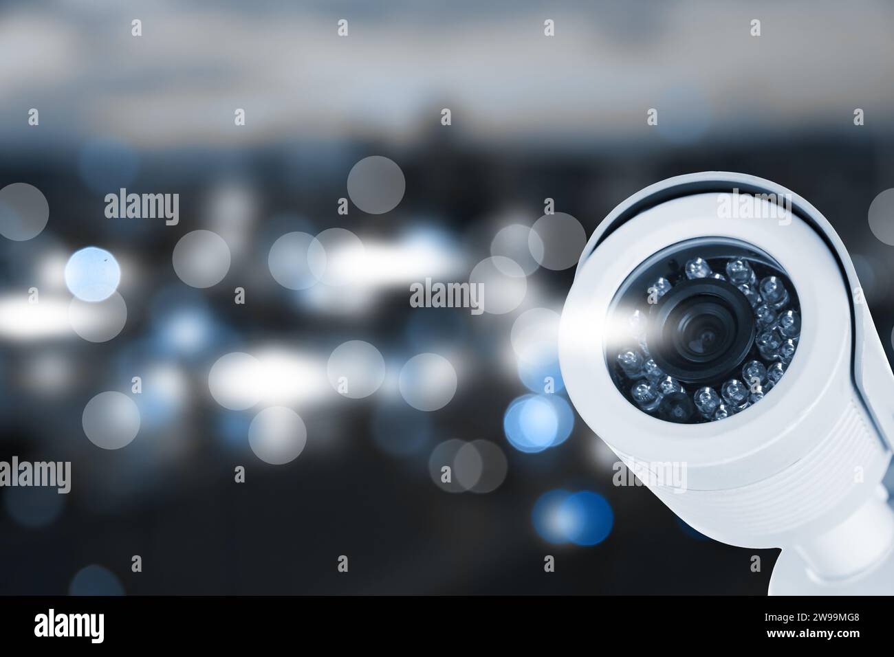 Modern security CCTV camera against blurred background, space for text ...