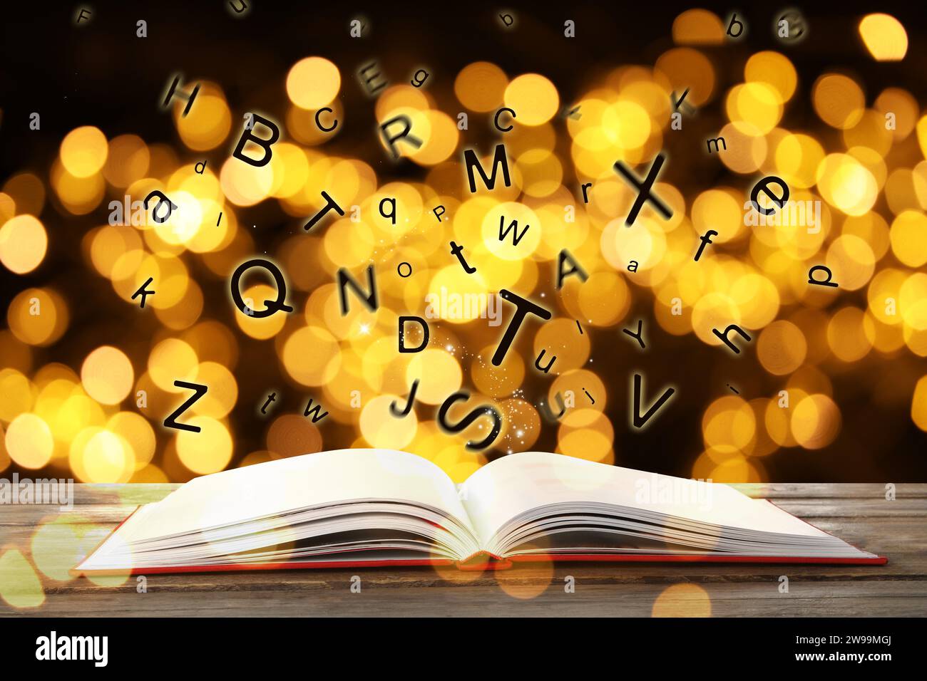 Letters flying out from open book on wooden table, bokeh effect Stock ...