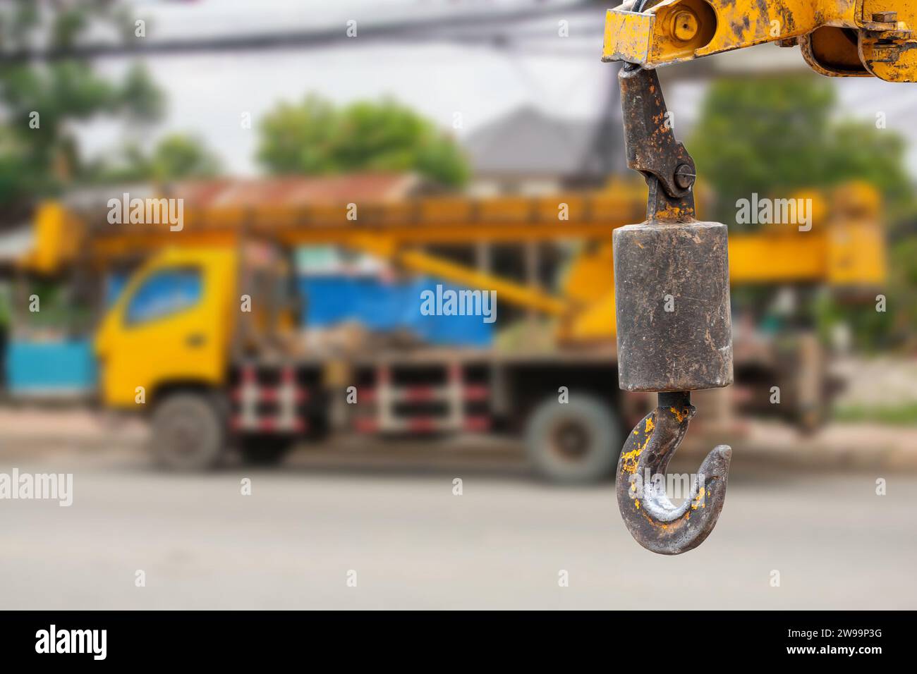 old cranes hooks hanging over crane truck background Stock Photo - Alamy