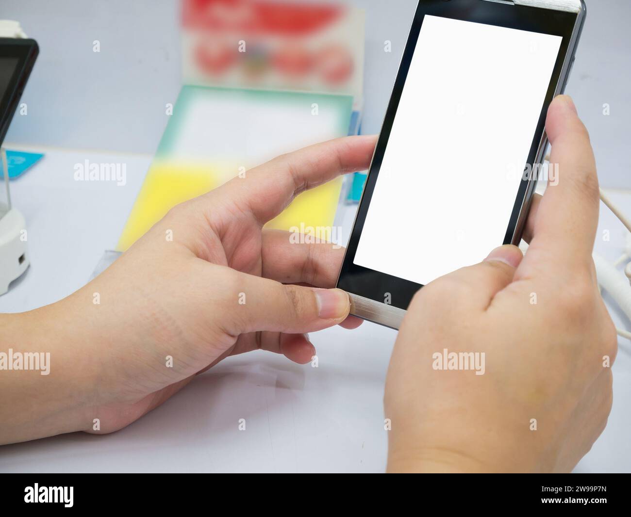 female hand hold mobile smartphone in mobile phone shop with mobile ... female hand hold mobile smartphone in mobile phone shop with mobile ...