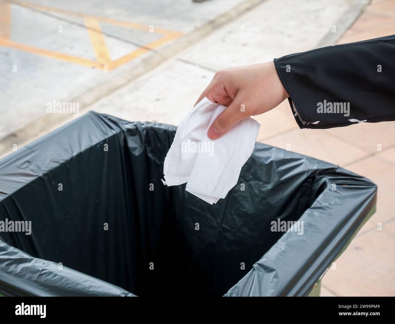 hand putting paper into trash bin Stock Photo - Alamy
