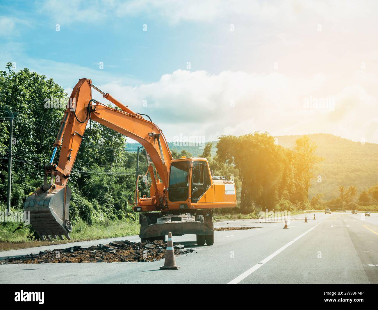 Excavator working at road construction site Stock Photo - Alamy