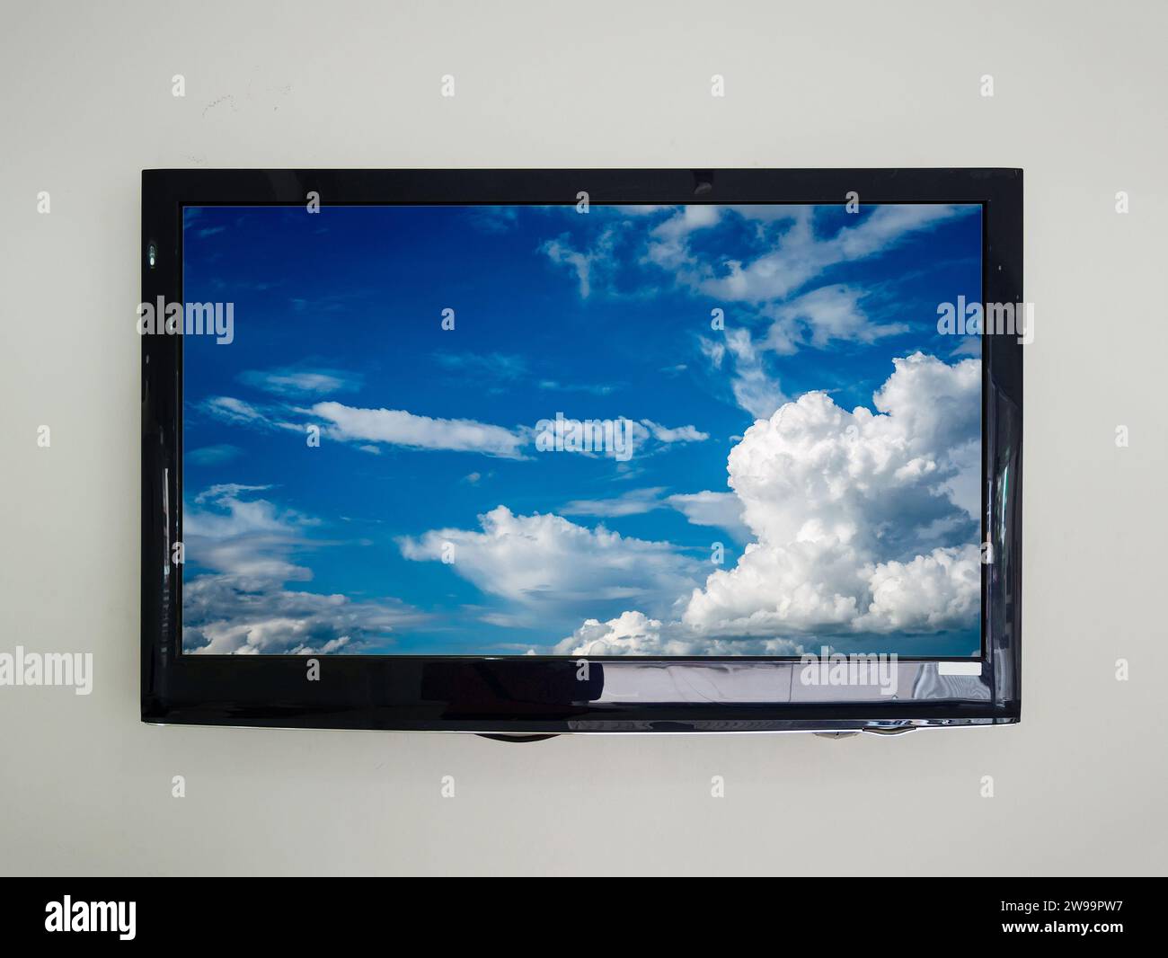Led tv on the wall background with clouds on television screen Stock ...