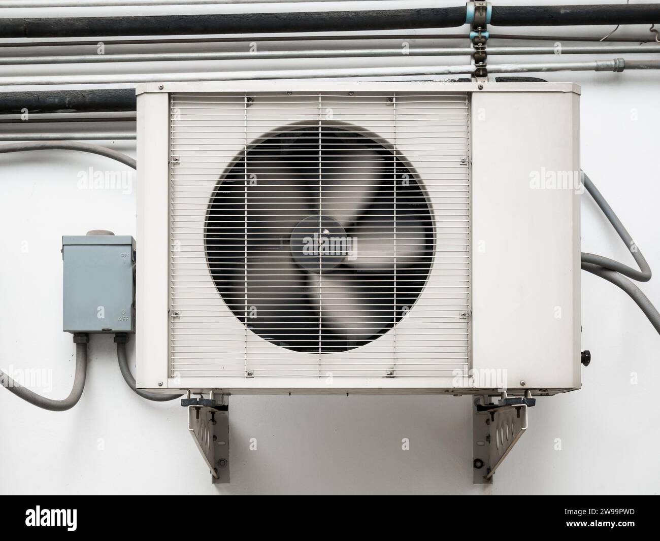 Air conditioner compressor unit installed outdoor in the old building ...