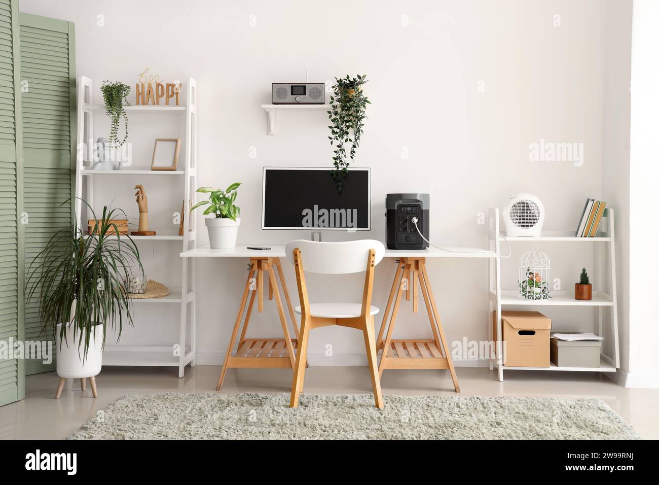 Comfortable workspace with modern computer and portable power station ...