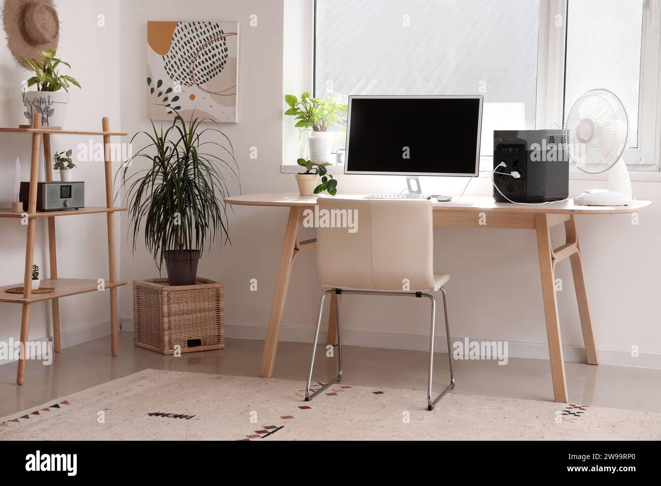 Comfortable workspace with modern computer and portable power station ...