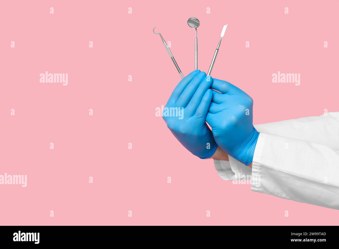 Dentist hands with dental tools on pink background. World Dentist Day ...