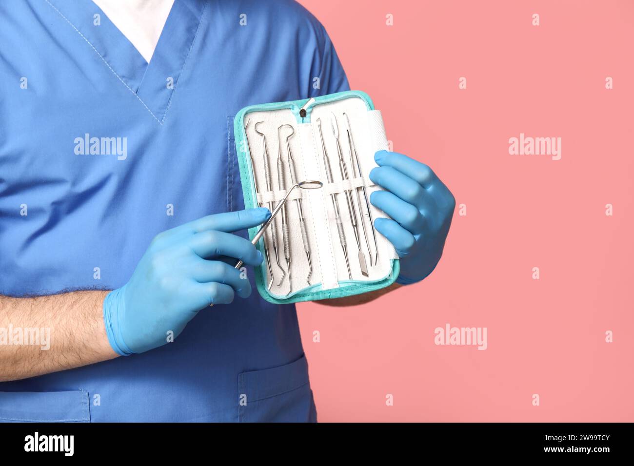 Dentist with set of dental tools on pink background. World Dentist Day ...