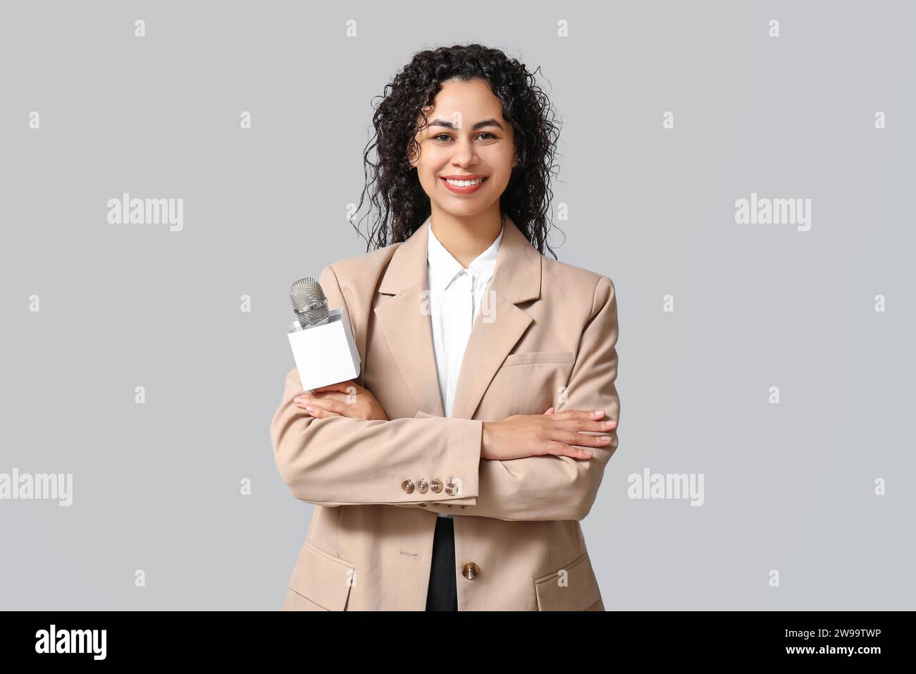 Beautiful young happy African-American female journalist with ...