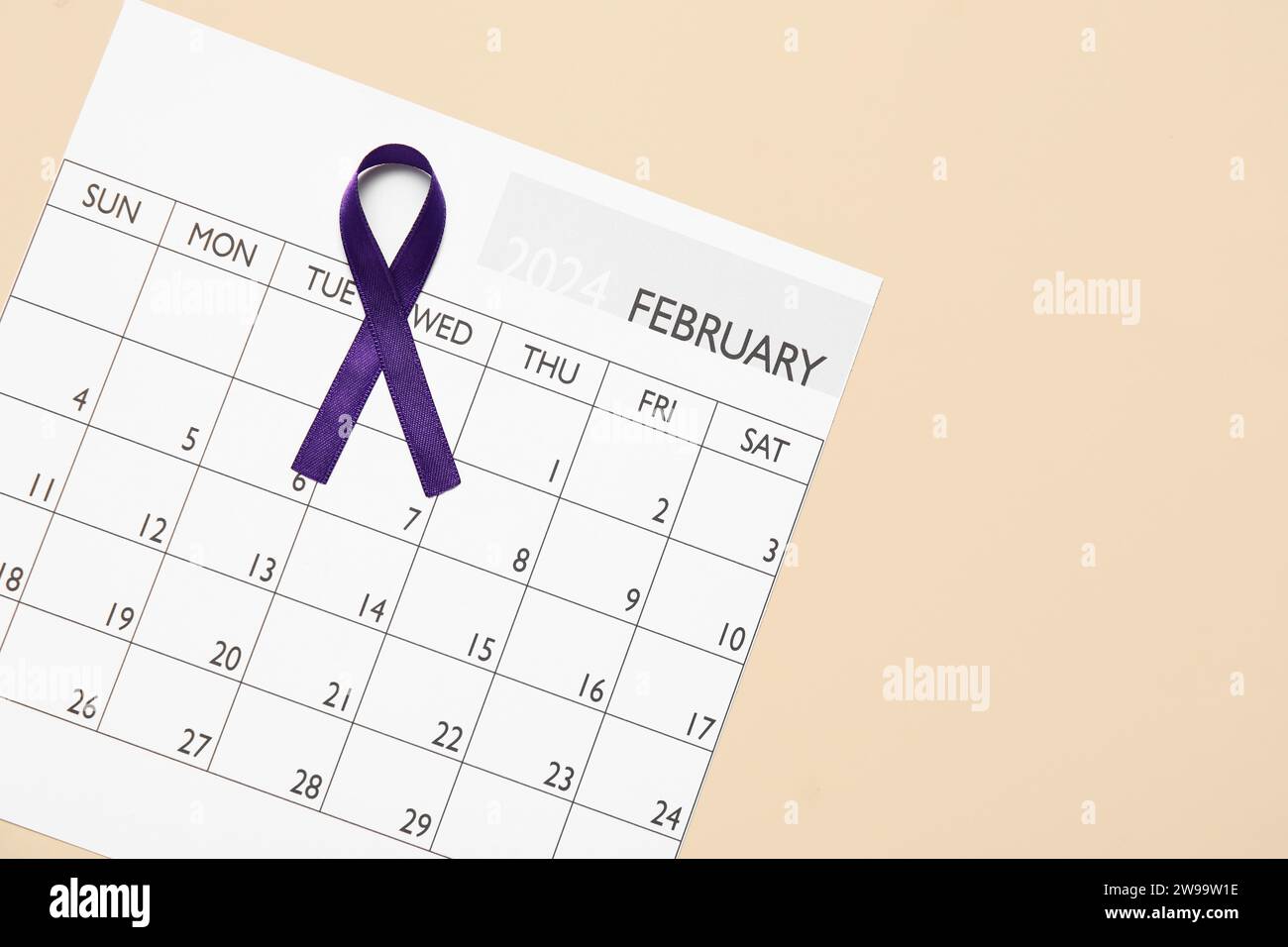 Purple ribbon and paper calendar on beige background. Cancer awareness ...
