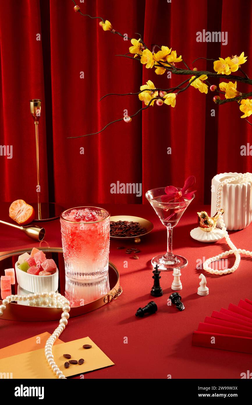 A Tet party table with colorful candy, a glass of juice, chess pieces ...