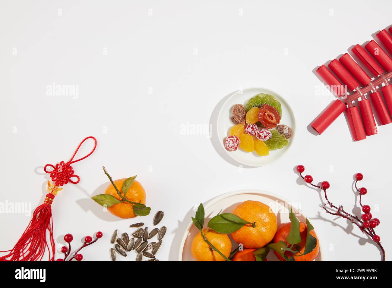 A plate of tangerines, a plate of jam, a string of red firecrackers, a ...