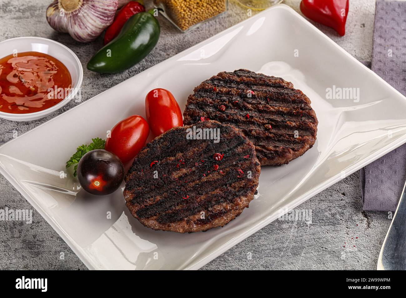 Grilled beef burger cutlet with sauce Stock Photo - Alamy