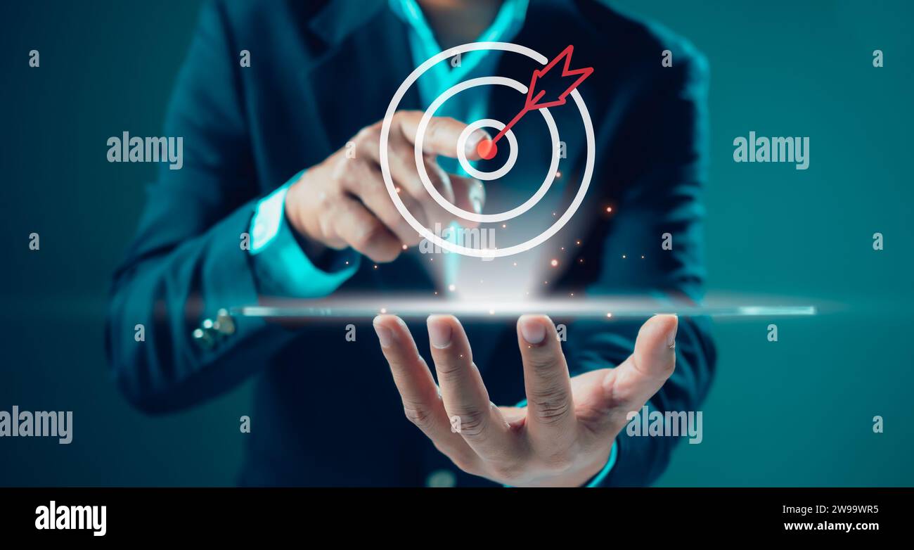 Businessman pointing finger to virtual target dart board, Success goals ...