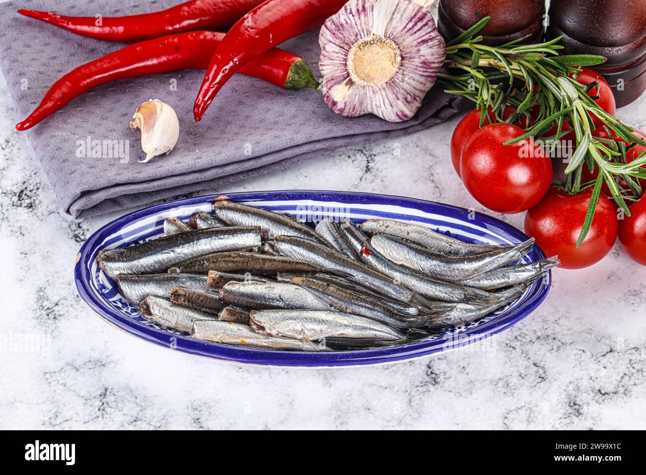 Pickled anchovy fish in the plate Stock Photo - Alamy