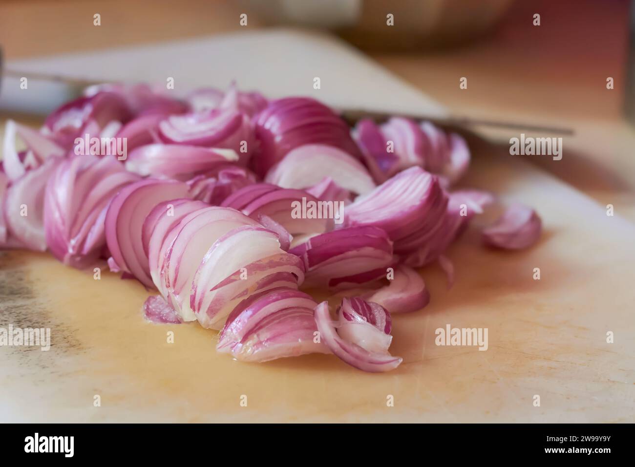 close-up of chopped or sliced red onion on cutting board, fresh ...