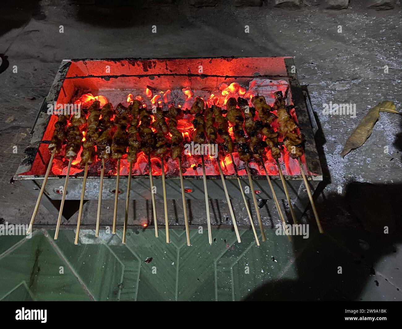Grilling chicken satay with a charcoal fire Stock Photo - Alamy