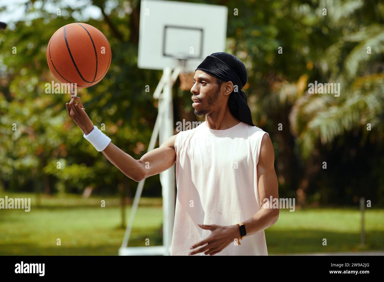 Streetball player spinning ball on finger, practicing new trick Stock ...