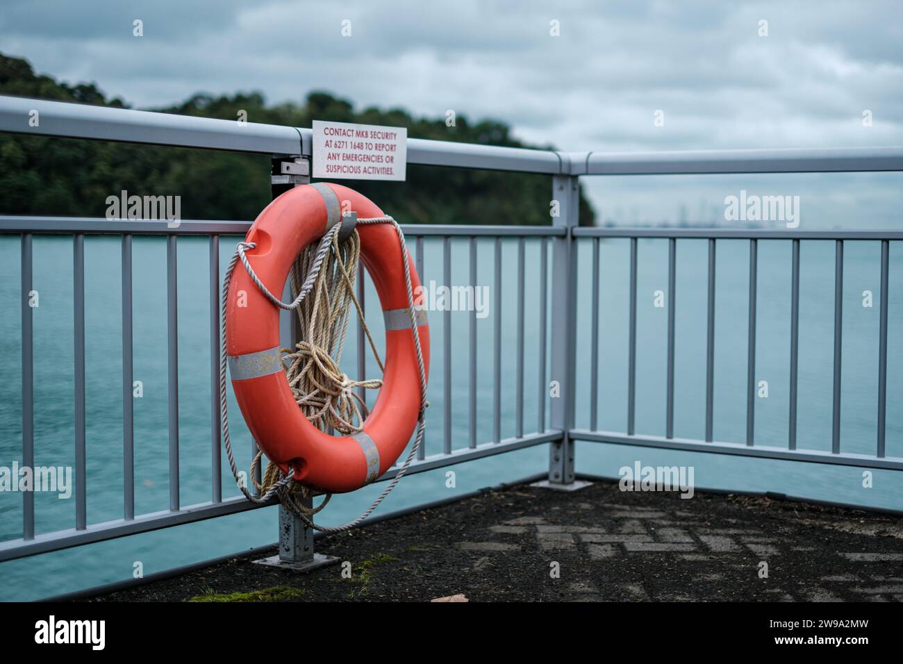 Orange Lifebuoy on Ocean Barricade Stock Photo - Alamy