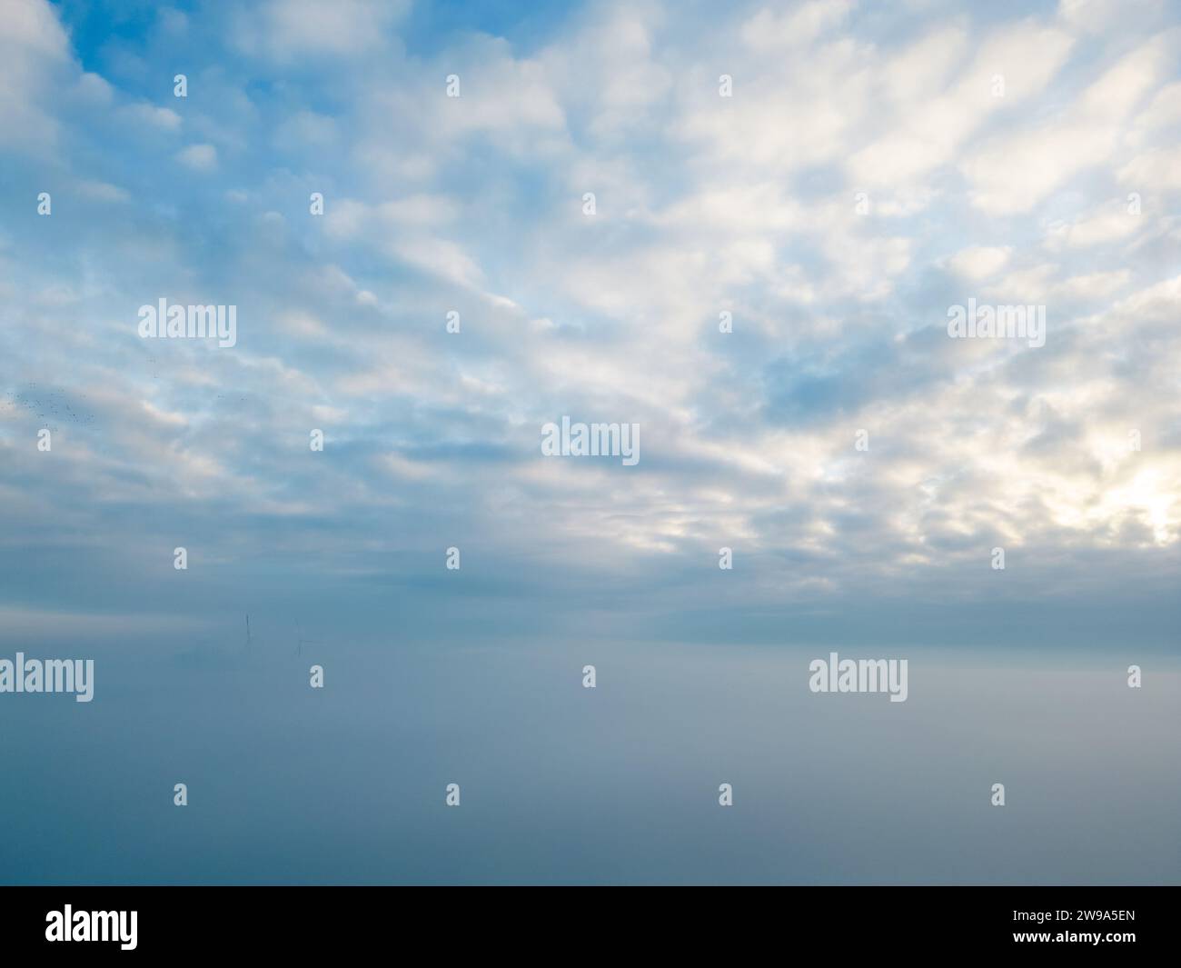 This image, captured by a drone above the mist, depicts a serene ...