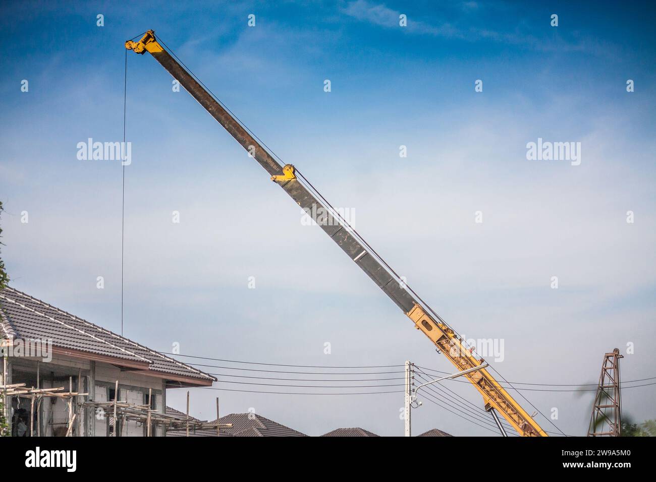 yellow telescopic arms of mobile construction crane truck lifting ...