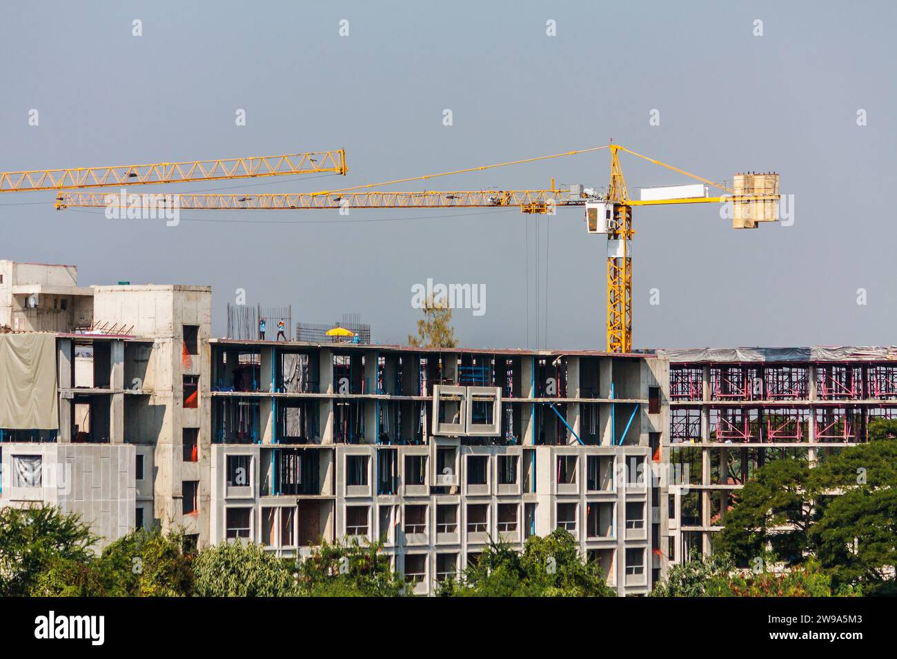 Construction tower crane at building site Stock Photo - Alamy