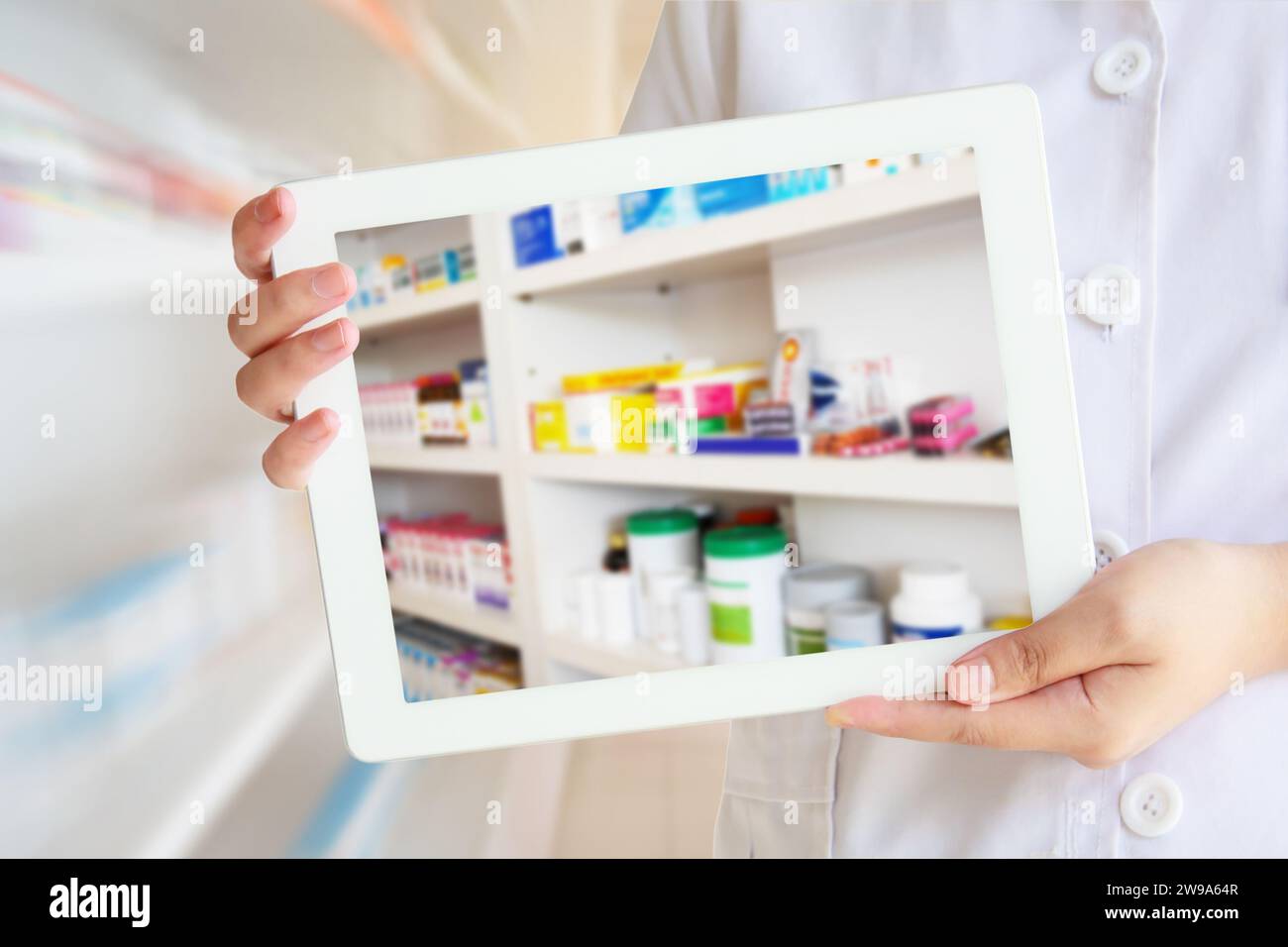 Female pharmacist showing tablet computer with medicine on pharmacy ...