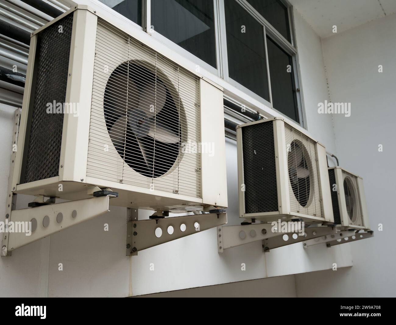 Air conditioner compressor unit installed outdoor in the old building ...