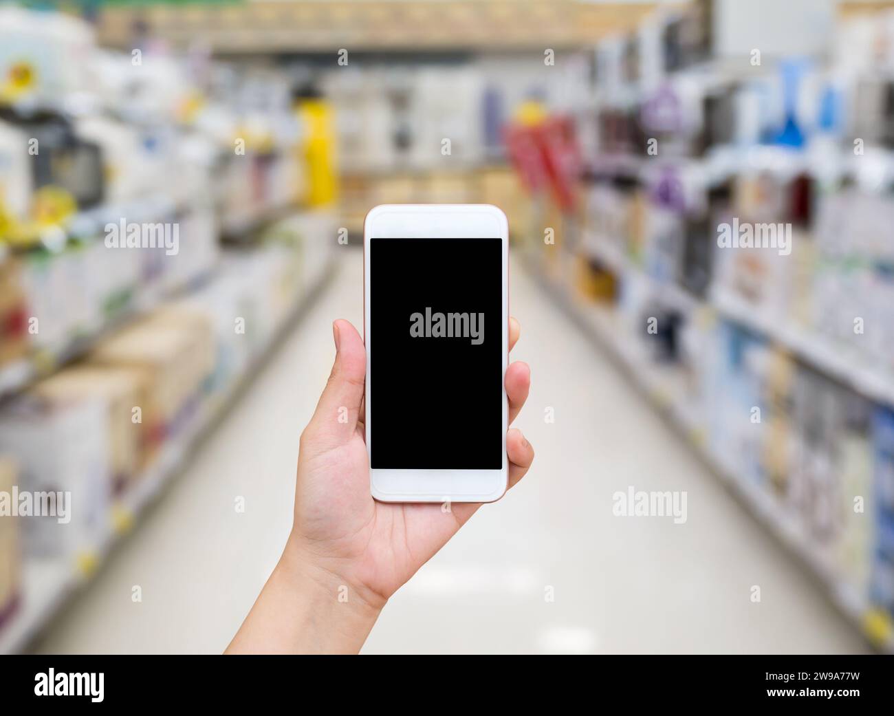 woman hand hold mobile smart phone with electronic department in ...