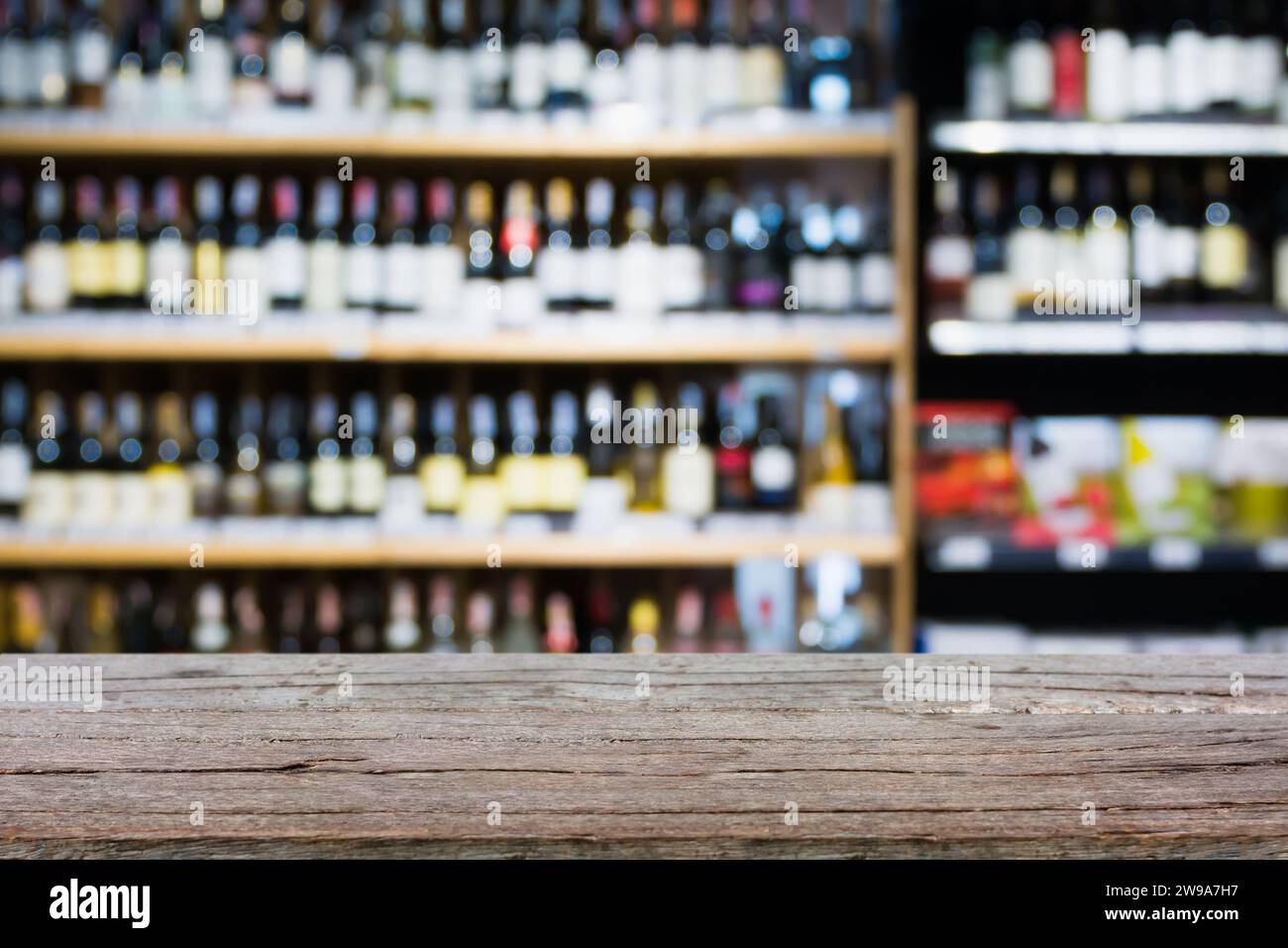 Wood table top with Abstract blur wine bottles on liquor alcohol ...