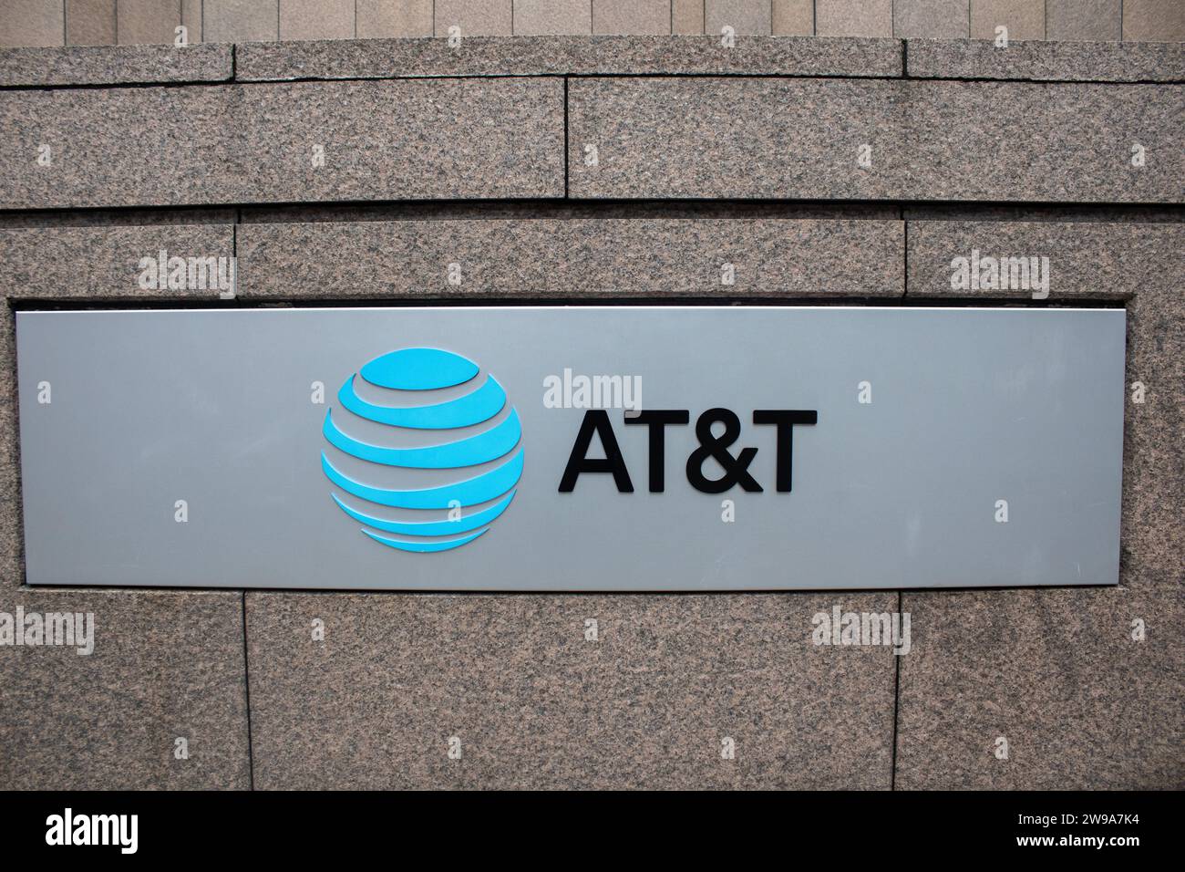 A sign for AT&T affixed to the exterior wall of a commercial building ...
