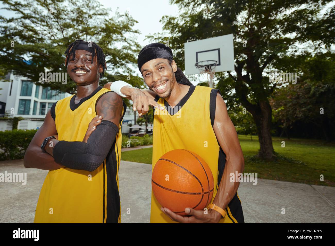 Portrait of happy excited streetball players in uniform posing at ...