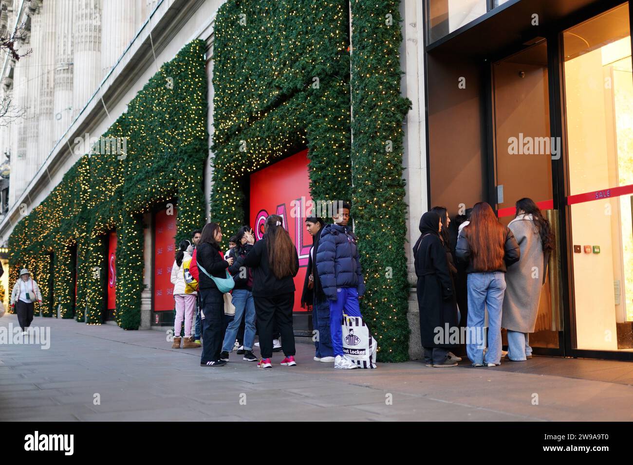 A small line of shoppers queueing at 8.15am outside Selfridges department store on London's ...