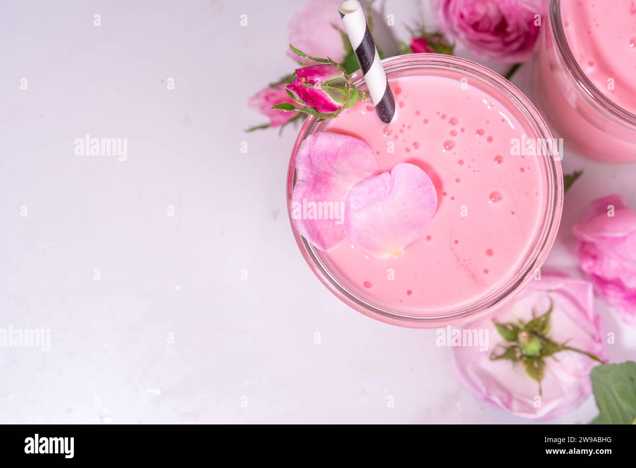 Rose flower milkshake, asian Moon milk drink. Pink matcha cocktail with ...