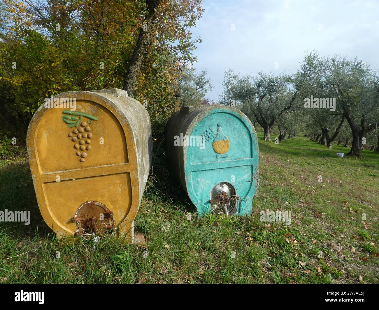 two large containers for wine in the field near the winery with the ...