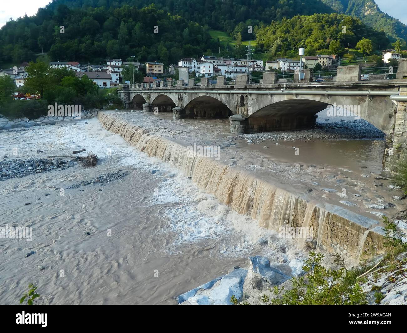 wide stream bed with brown water due to the heavy rain that fell in the ...