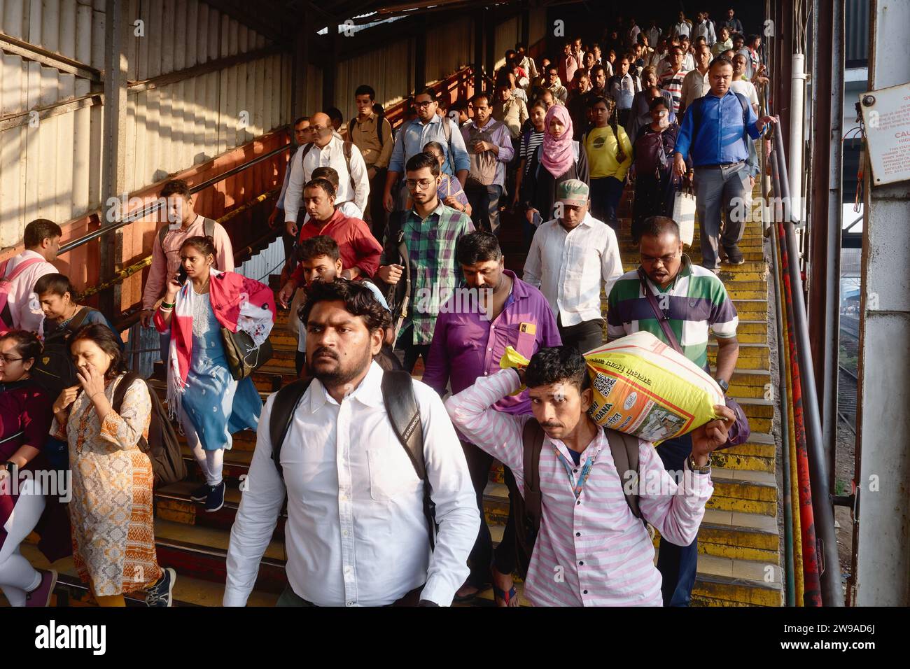 During morning rush hour, a throng of Mumbai railway commuters descends ...