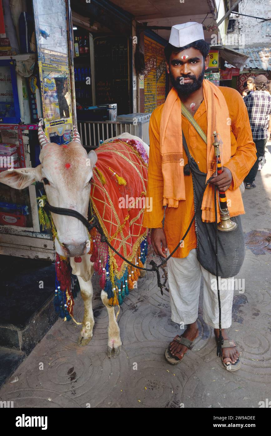 An Indian man from Maharashtra state wandering with his holy cow to ...