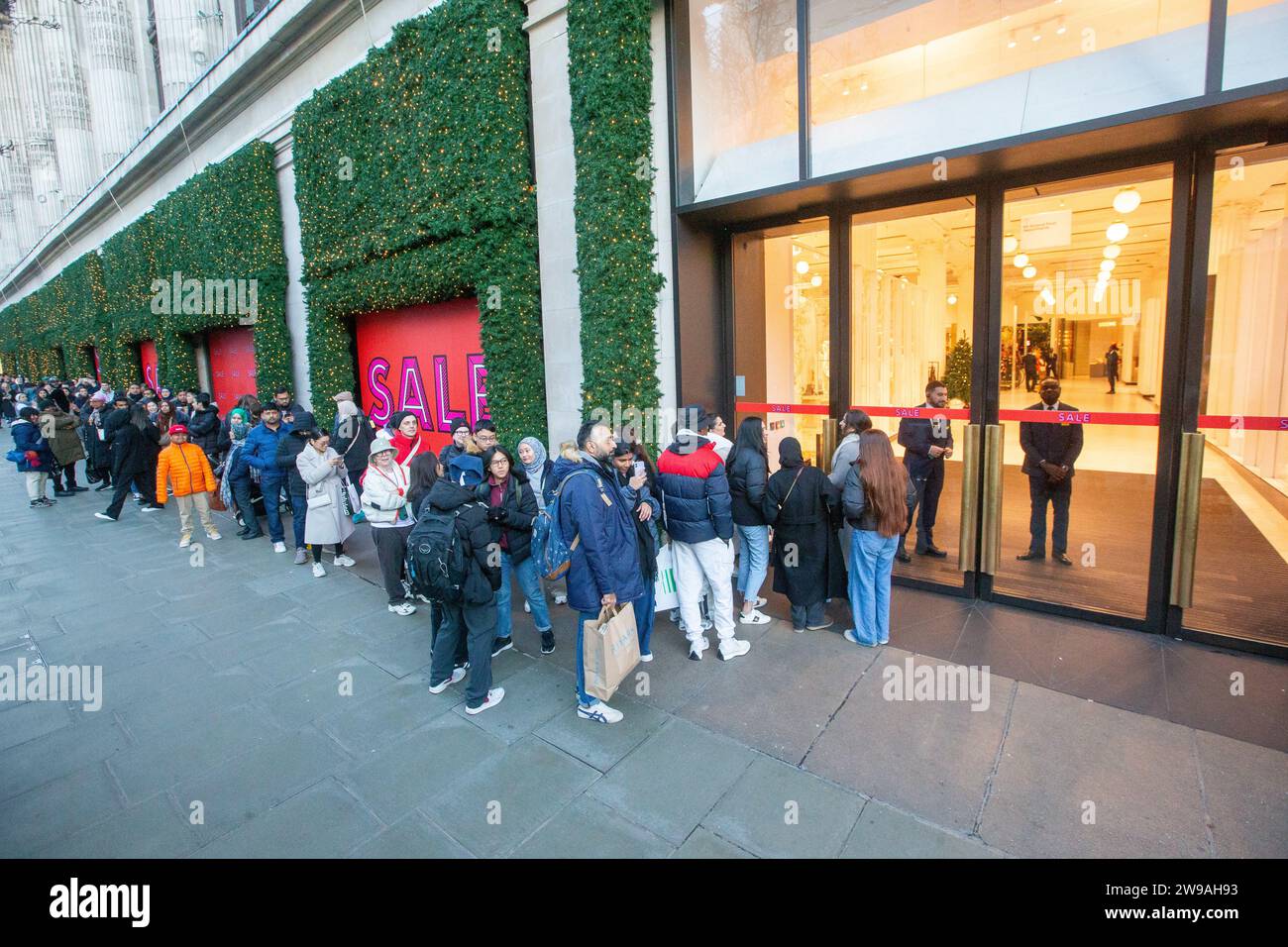 London, England, UK. 26th Dec, 2023. Customers are seen in a queue ...
