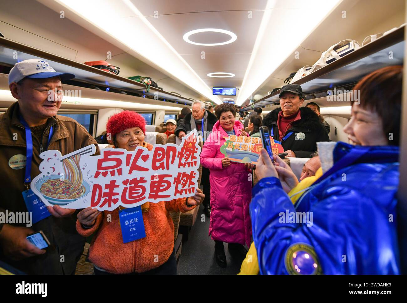 Yibin(Sichuan. 26th Dec, 2023. Passengers pose for photos on the high ...