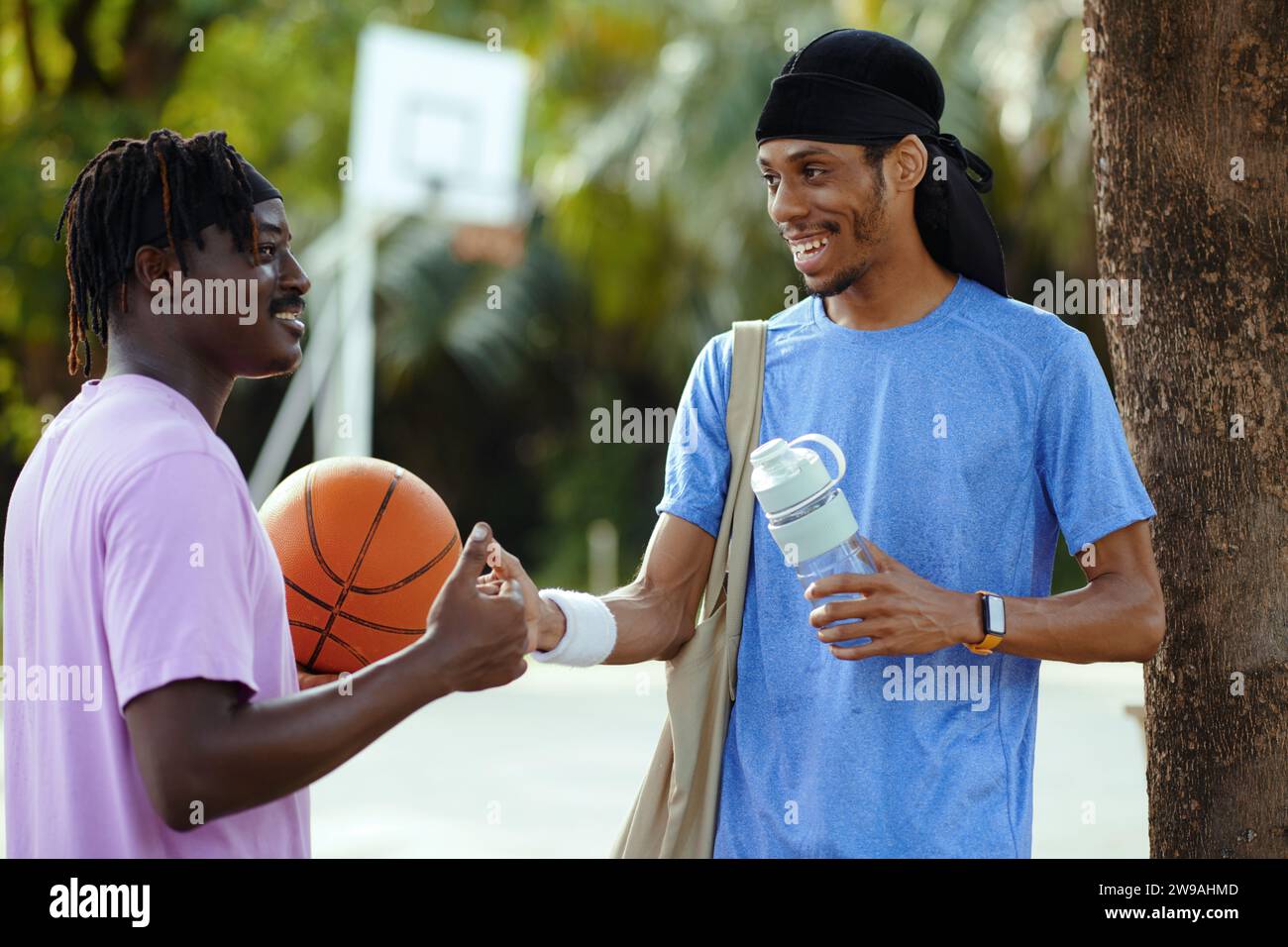 Black men having secret handshake, friends meeting to play basketball ...