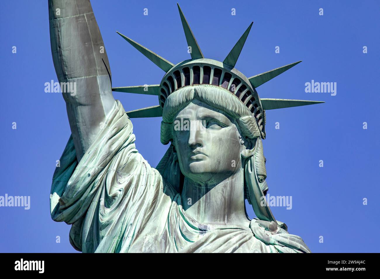The Statue of Liberty holding her torch on a sunny day in Manhattan ...