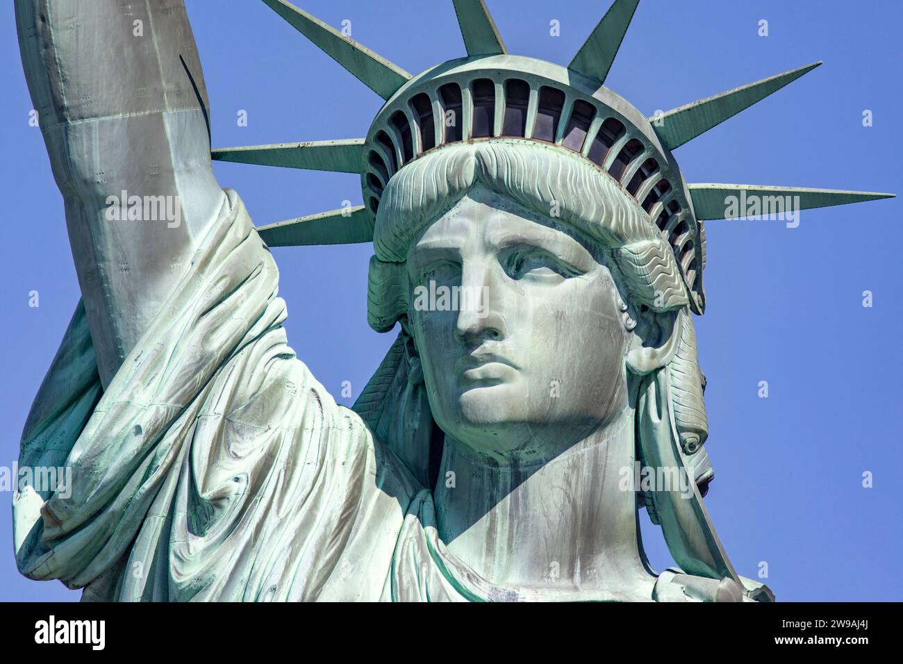 Photograph of the Statue of Liberty holding her torch on a sunny day in ...