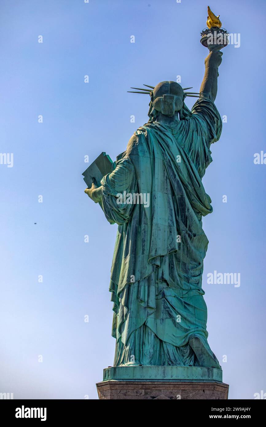 Rear vertical photo of the Statue of Liberty holding her torch on a ...