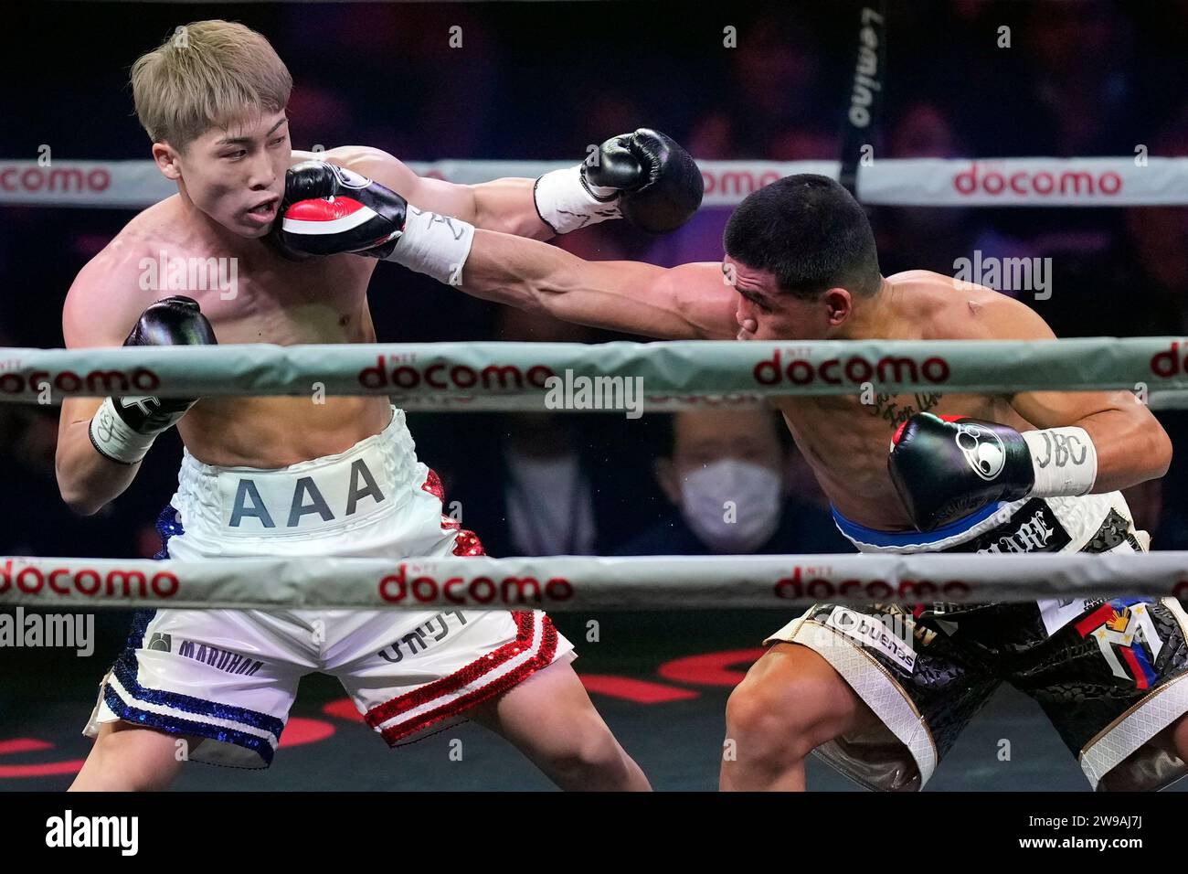 Marlon Tapales of the Philippines, right, punches Naoya Inoue of Japan ...