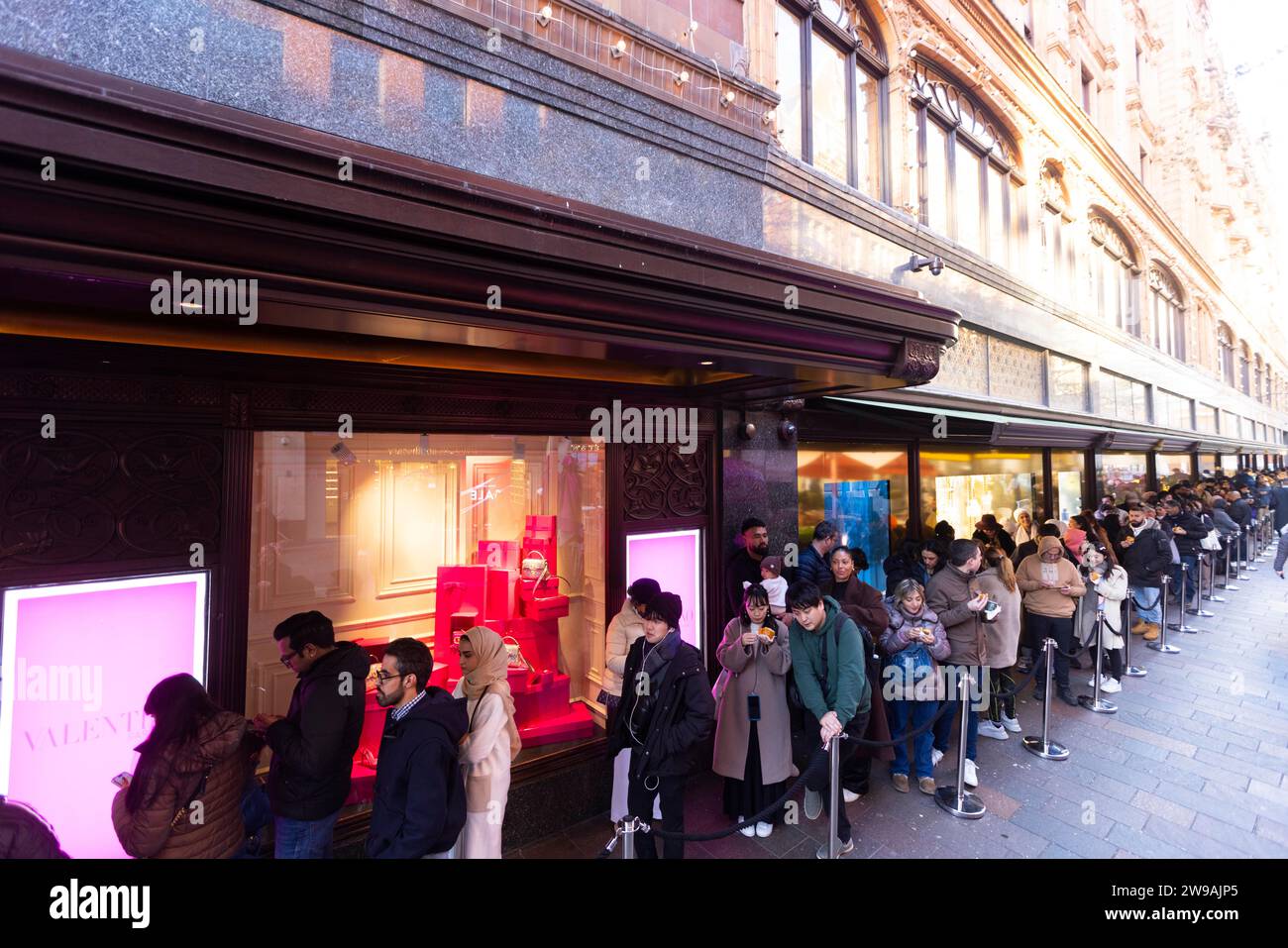 EDITORIAL USE ONLY Customers queue outside Harrods in Knightsbridge ...