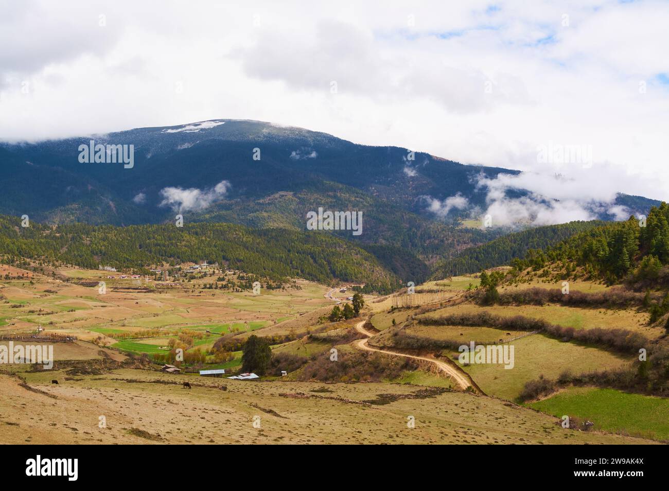 The picturesque Ura Valley in spring with clouds over the mountains, a ...
