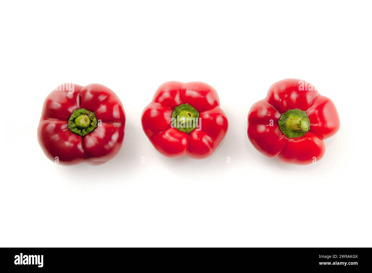 Three round red bell pepper (capsicum) known as sweet bell pepper ...