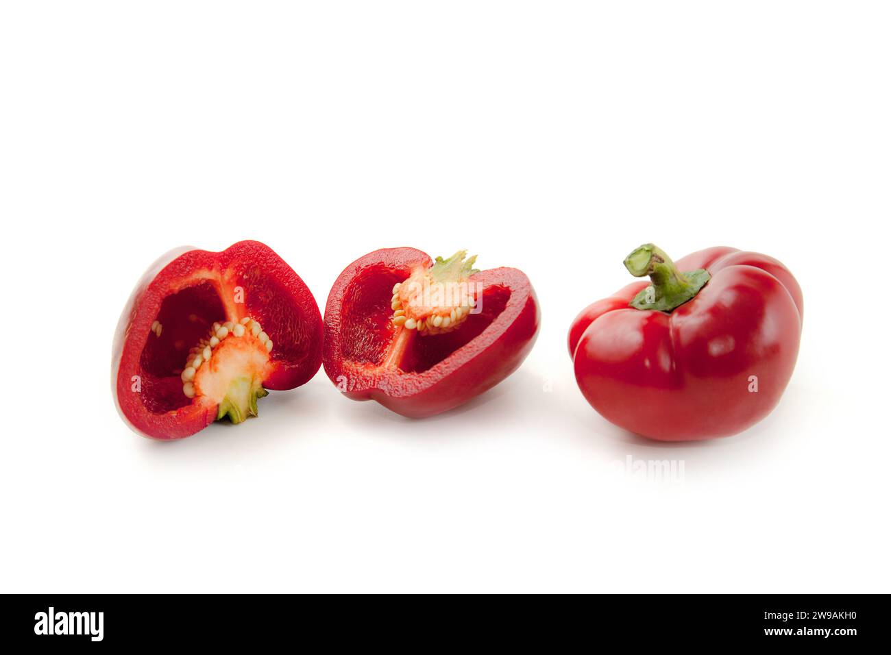 Whole and half of red bell pepper (capsicum) known as sweet bell pepper ...