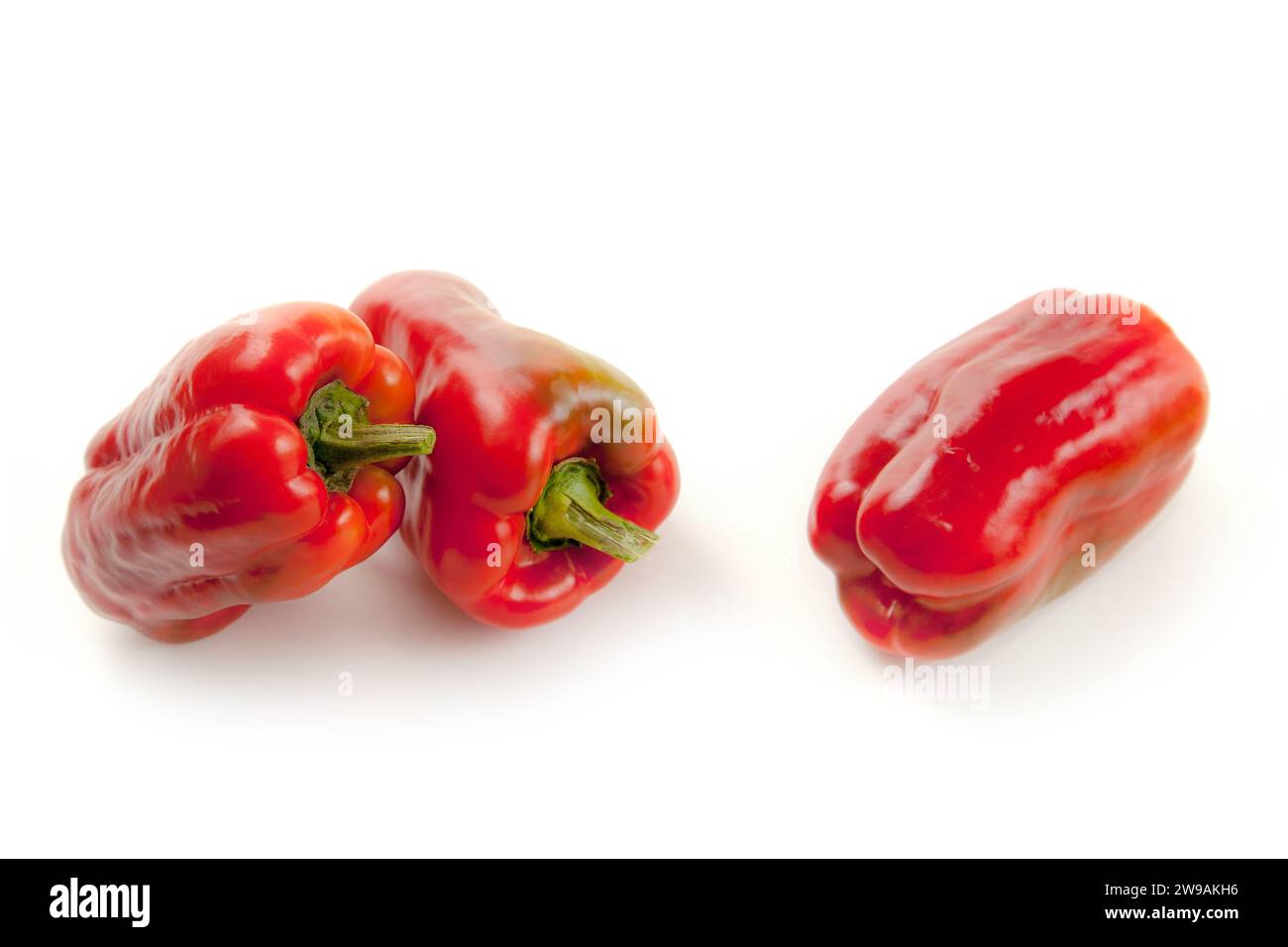 Three whole red bell pepper (capsicum) known as sweet bell pepper ...